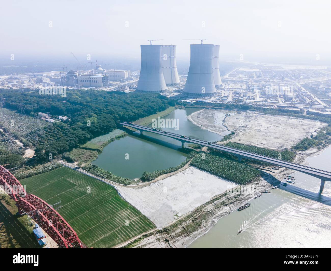 Aerial view of rooppur nuclear power plant with cooling towers, bridge ...