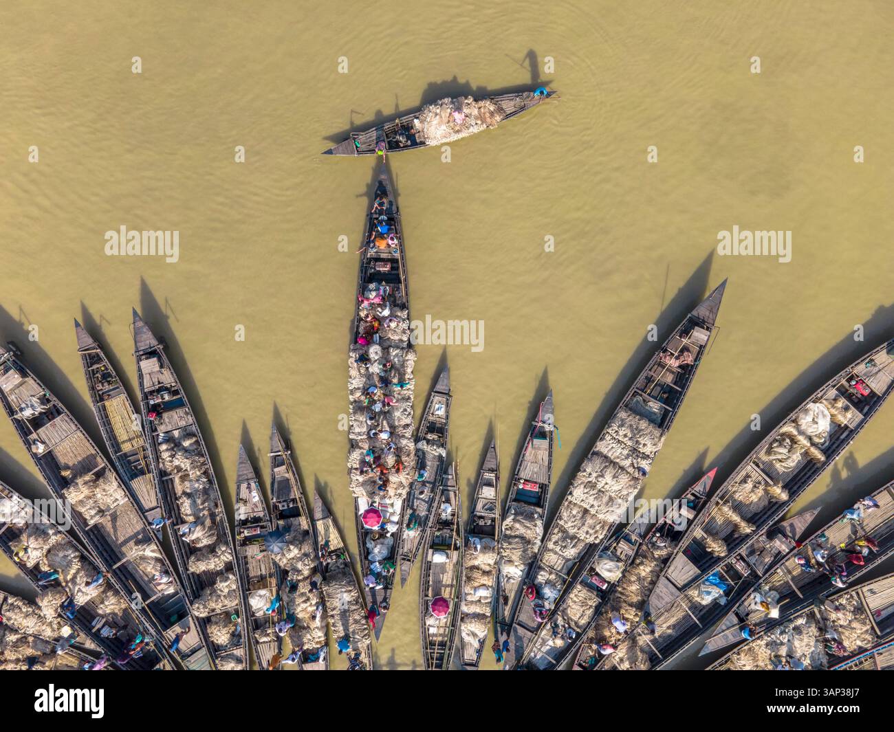 Aerial view of a bustling jute market with colorful boats along the ...