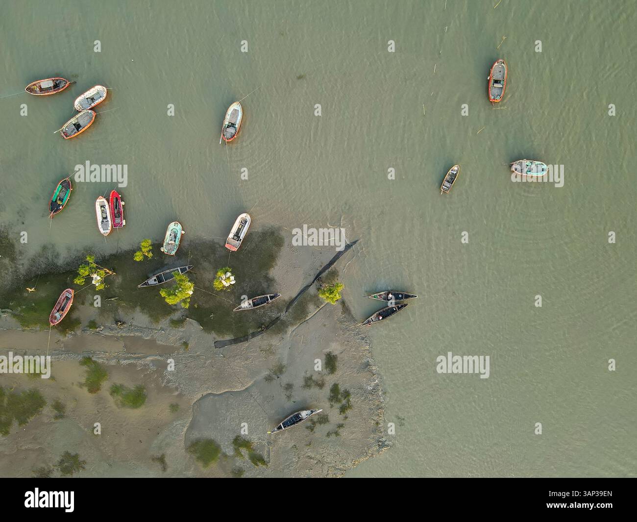 Aerial view of serene Dhumkhali sea beach at sunset with untouched waves and boats, Chittagong ...