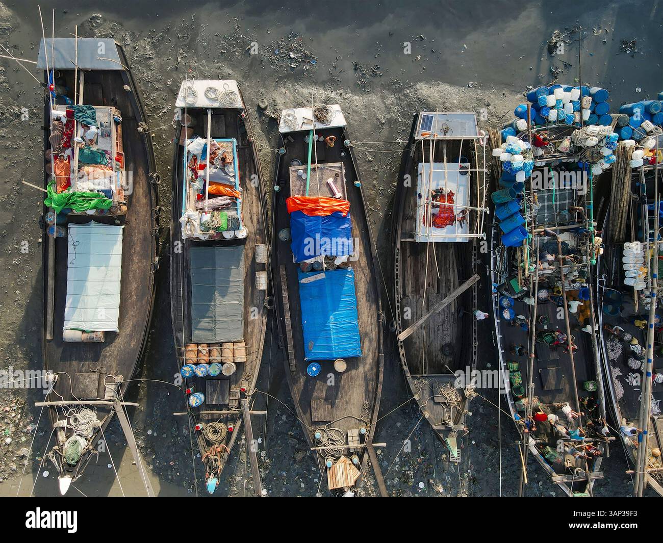 Chittagong, Bangladesh - 10 September 2022: Aerial view of fishermen resting on boats along the ...