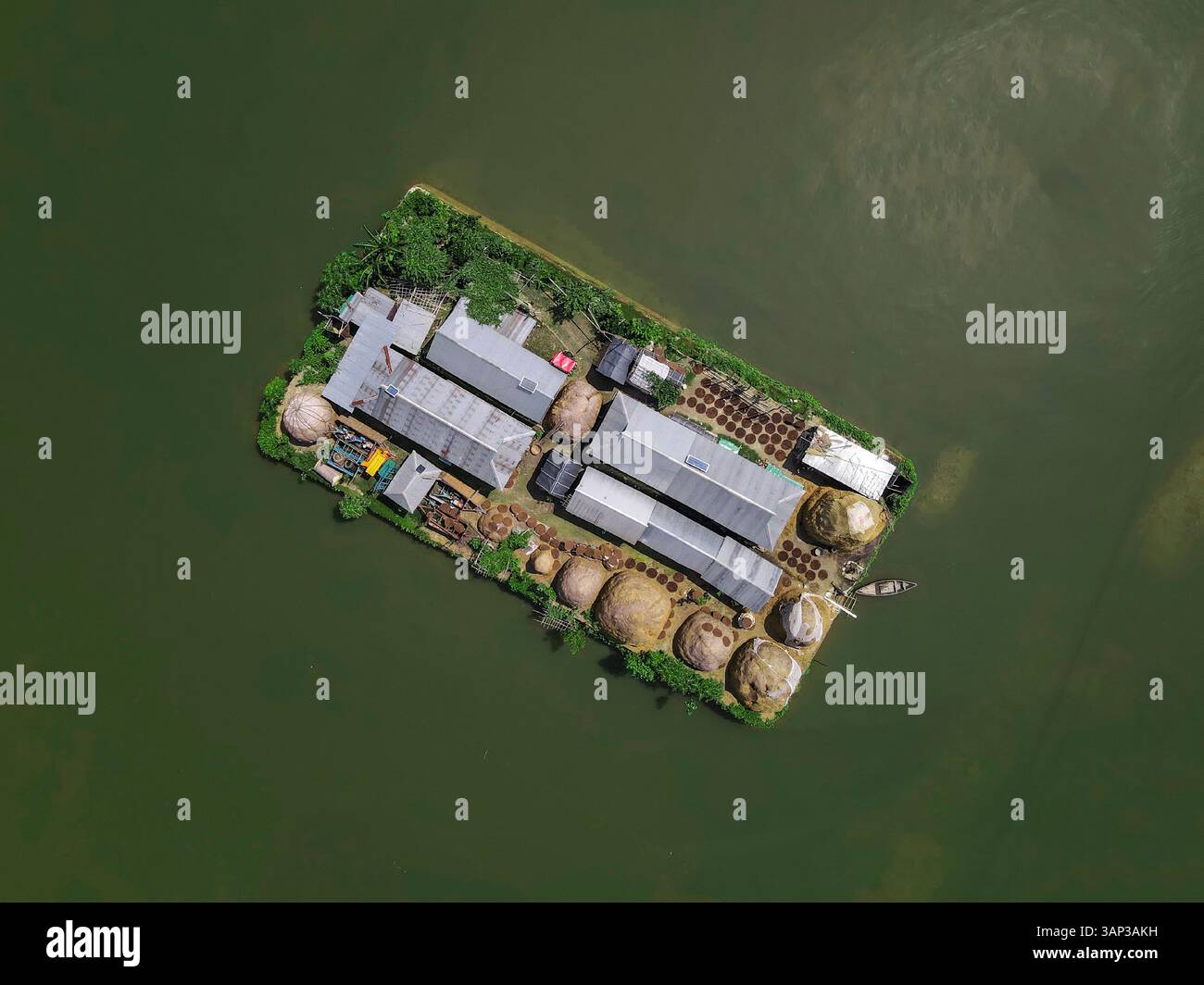 Aerial view of beautiful homes in the haor area surrounded by water ...