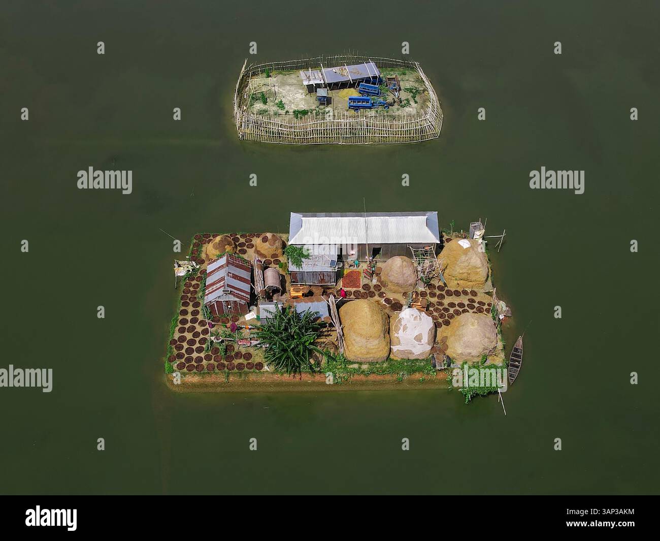 Aerial view of traditional homes amidst floodwaters in the haor area ...