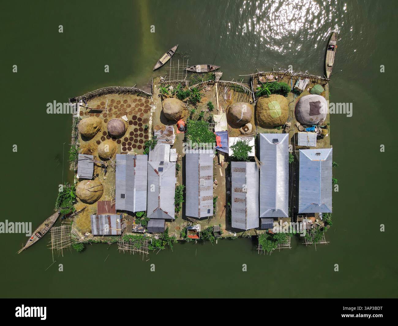 Aerial view of flood-affected homes and a village in the haor area ...