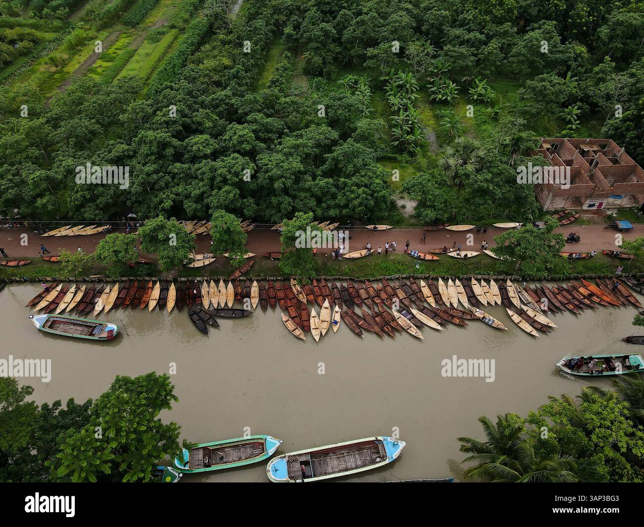 Aerial view of bustling boat markets during monsoon season with vibrant greenery and a river ...