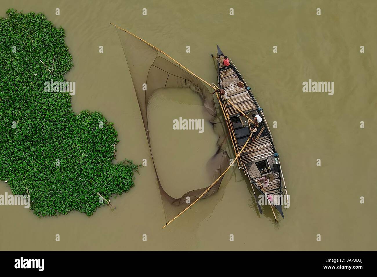 Aerial view of fishermen in boats using nets on the clear waters of the ...