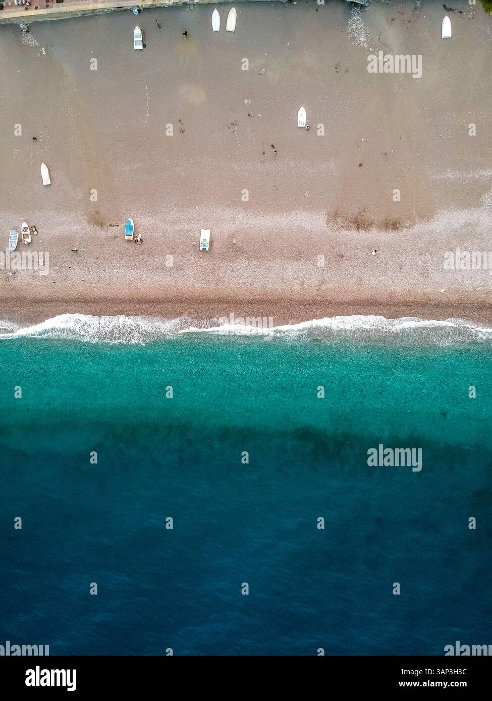 Aerial view of people on the beach along the shore in Letojanni ...