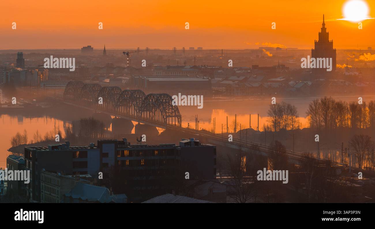 Sunrise Over Riga's Old Town with Railway Bridge and Landmarks Stock Photo - Alamy