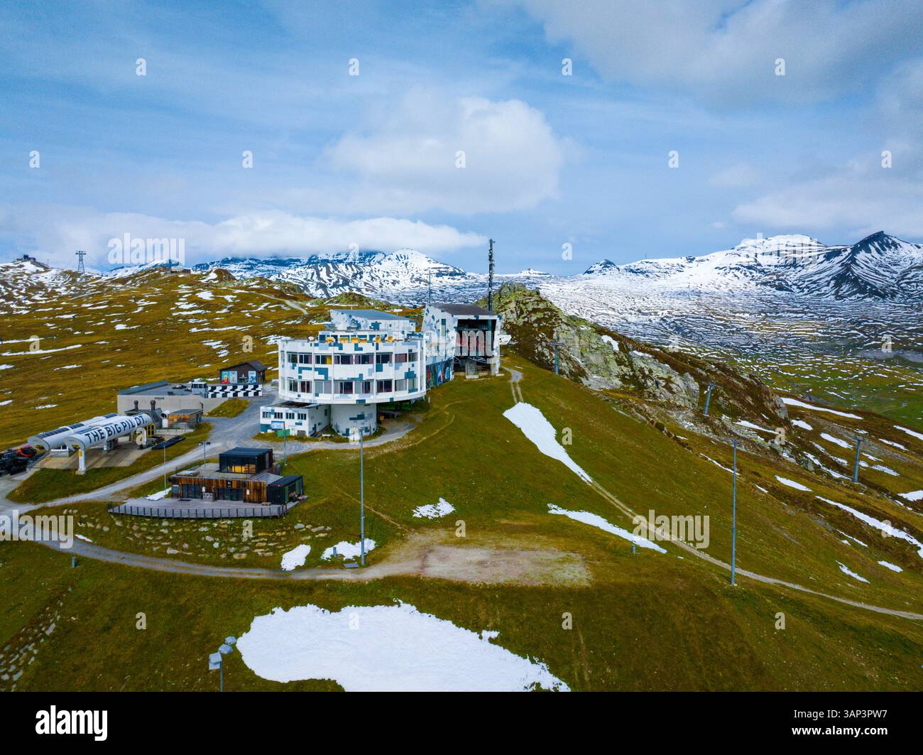 Aerial view of majestic snow-covered mountains and a scenic ski resort ...