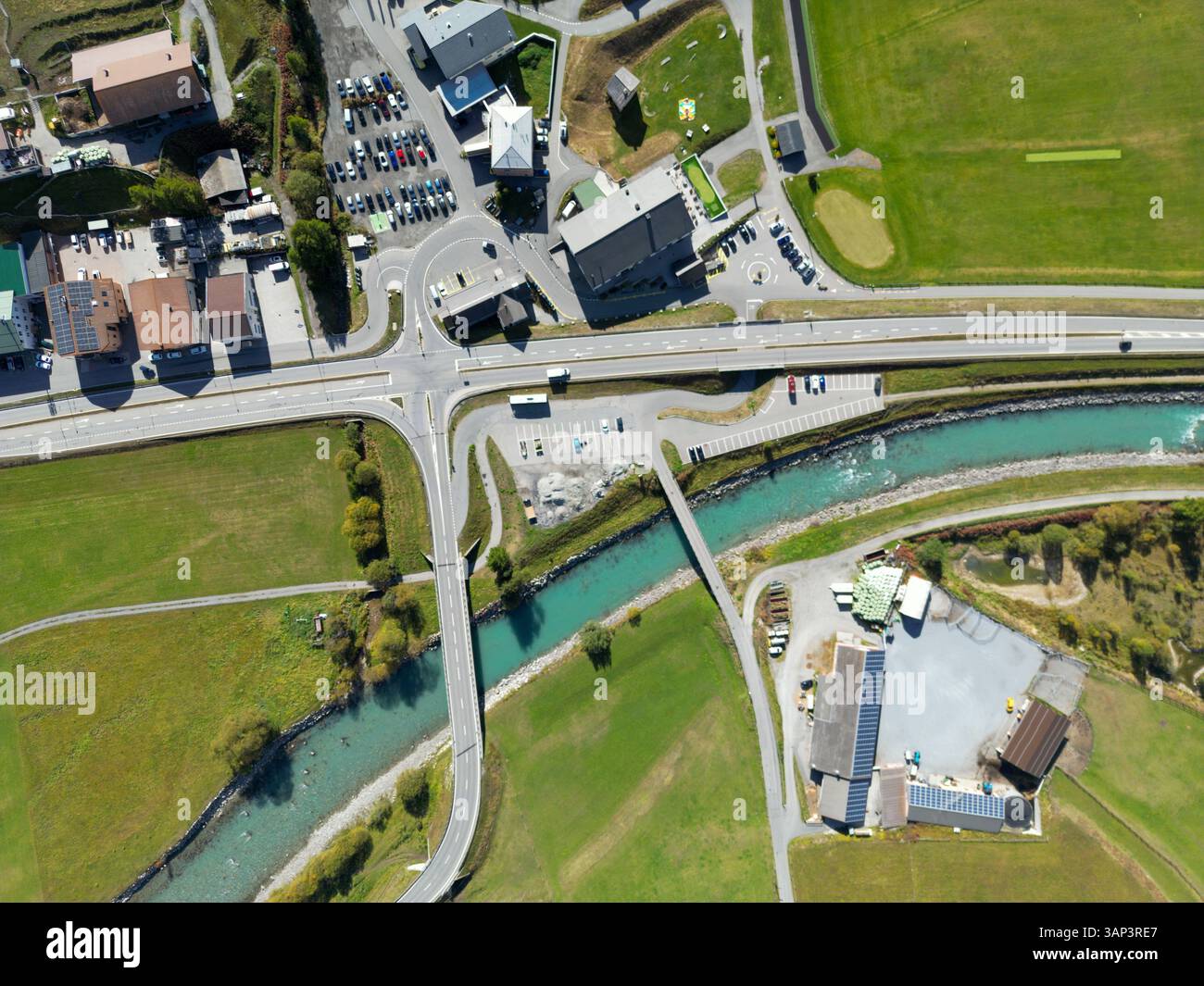 Aerial view of scenic Zuoz town with modern architecture, roads, river ...