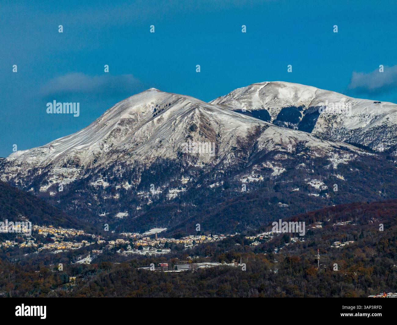 Aerial view of snow-capped majestic mountains and serene forests ...