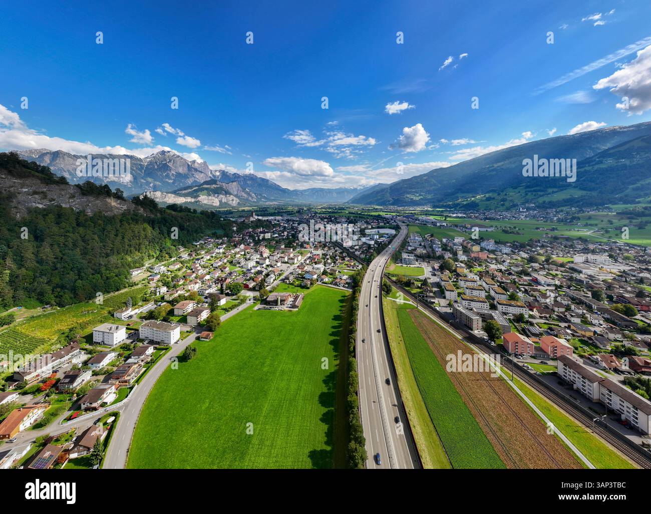 Aerial view of a picturesque town surrounded by green fields and ...
