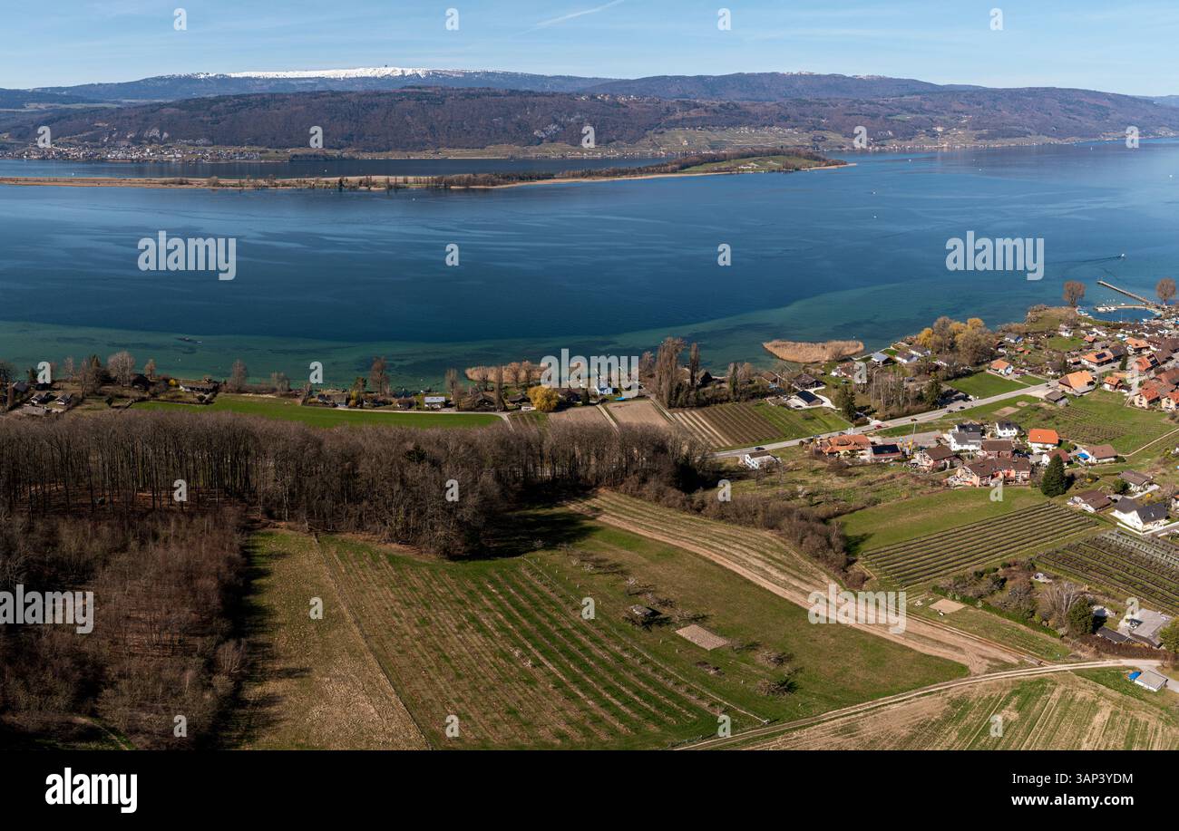 Aerial view of village, fields, and mountains by Lake Biel, Luscherz ...