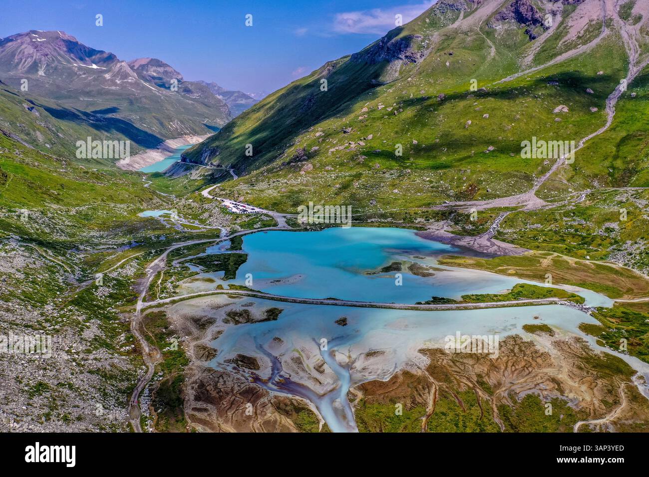 Aerial view of vibrant turquoise Moiry Glacier Lake amidst majestic ...