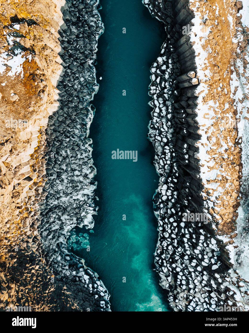 Aerial drone top-down view of Studlagil Canyon, river and pillar shaped ...