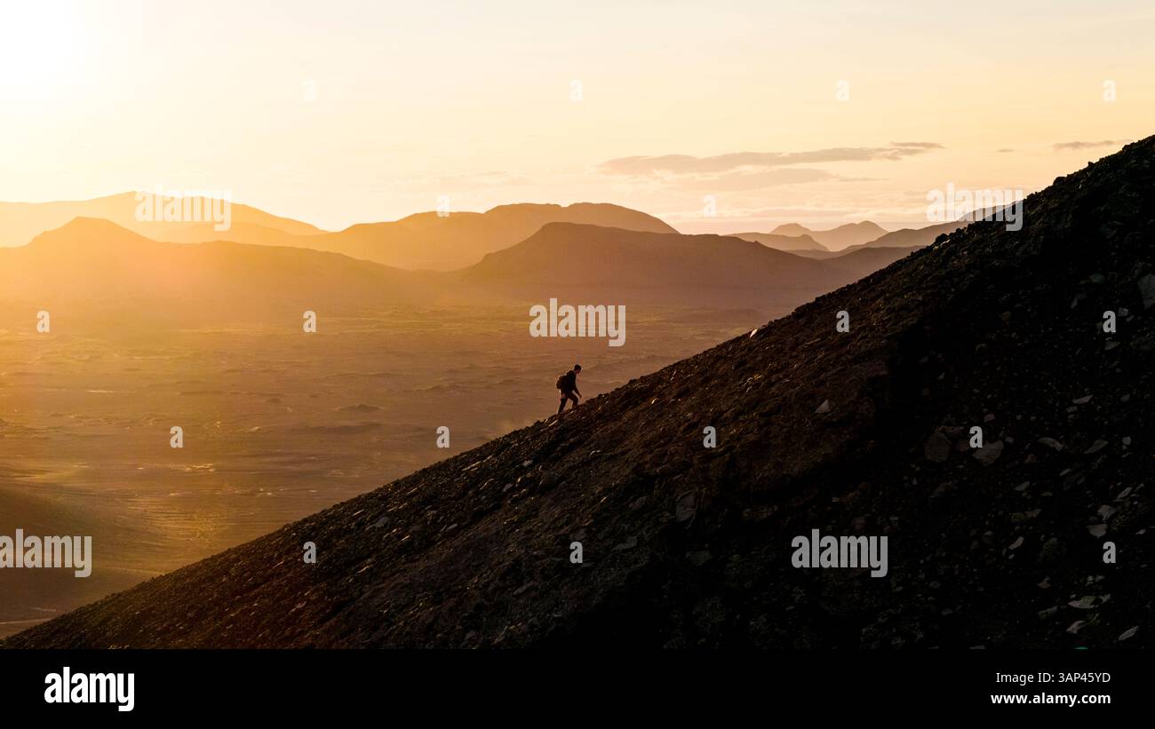 Aerial drone view of a silhouette person walking uphill on Blahylur ...