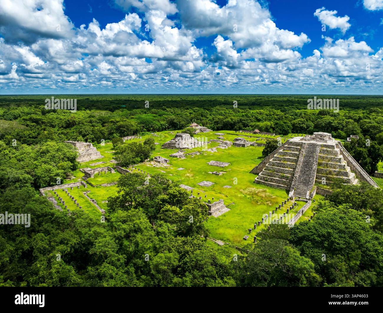Aerial view of ancient maya pyramids surrounded by lush greenery and ...