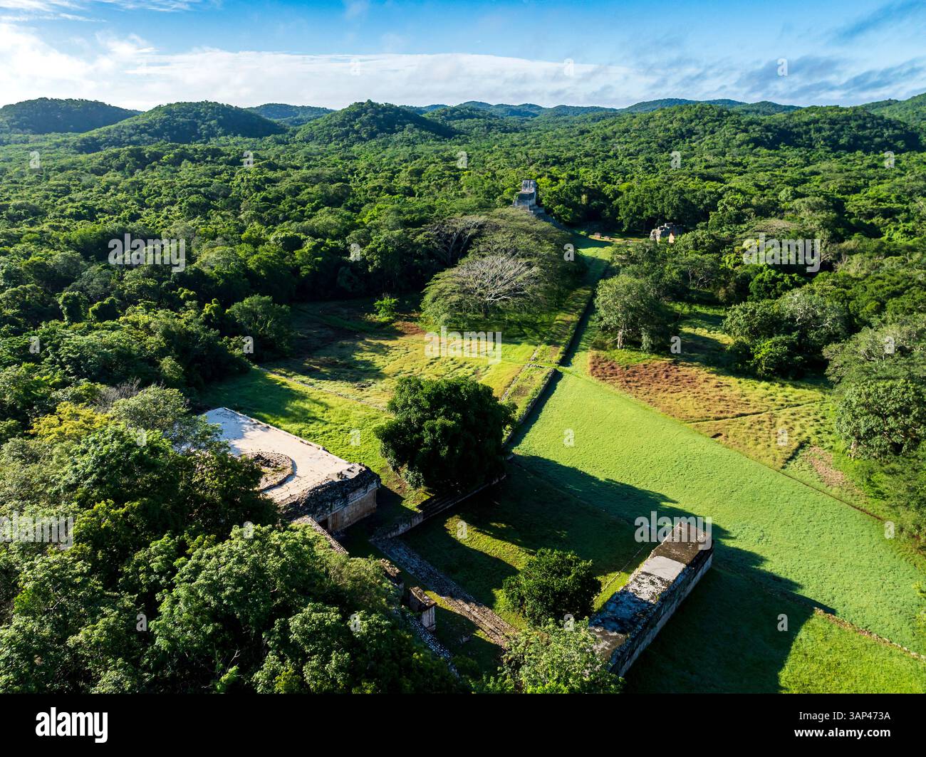 Aerial view of ancient ruins surrounded by lush forest and hills, Labna ...