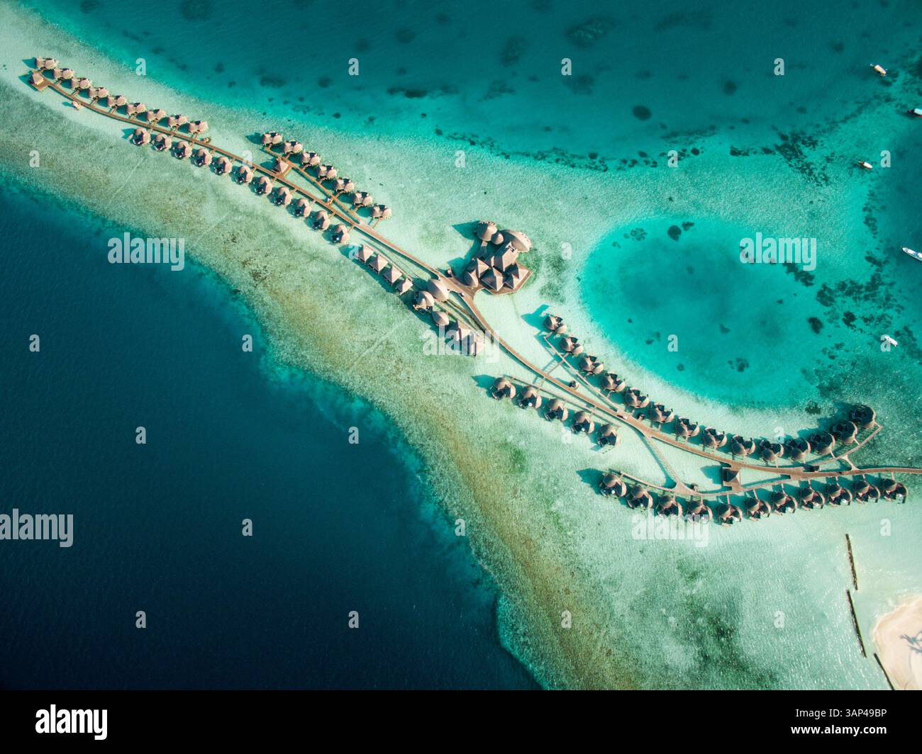 Aerial view above a group of bungalows in a luxury resort, Maldives ...