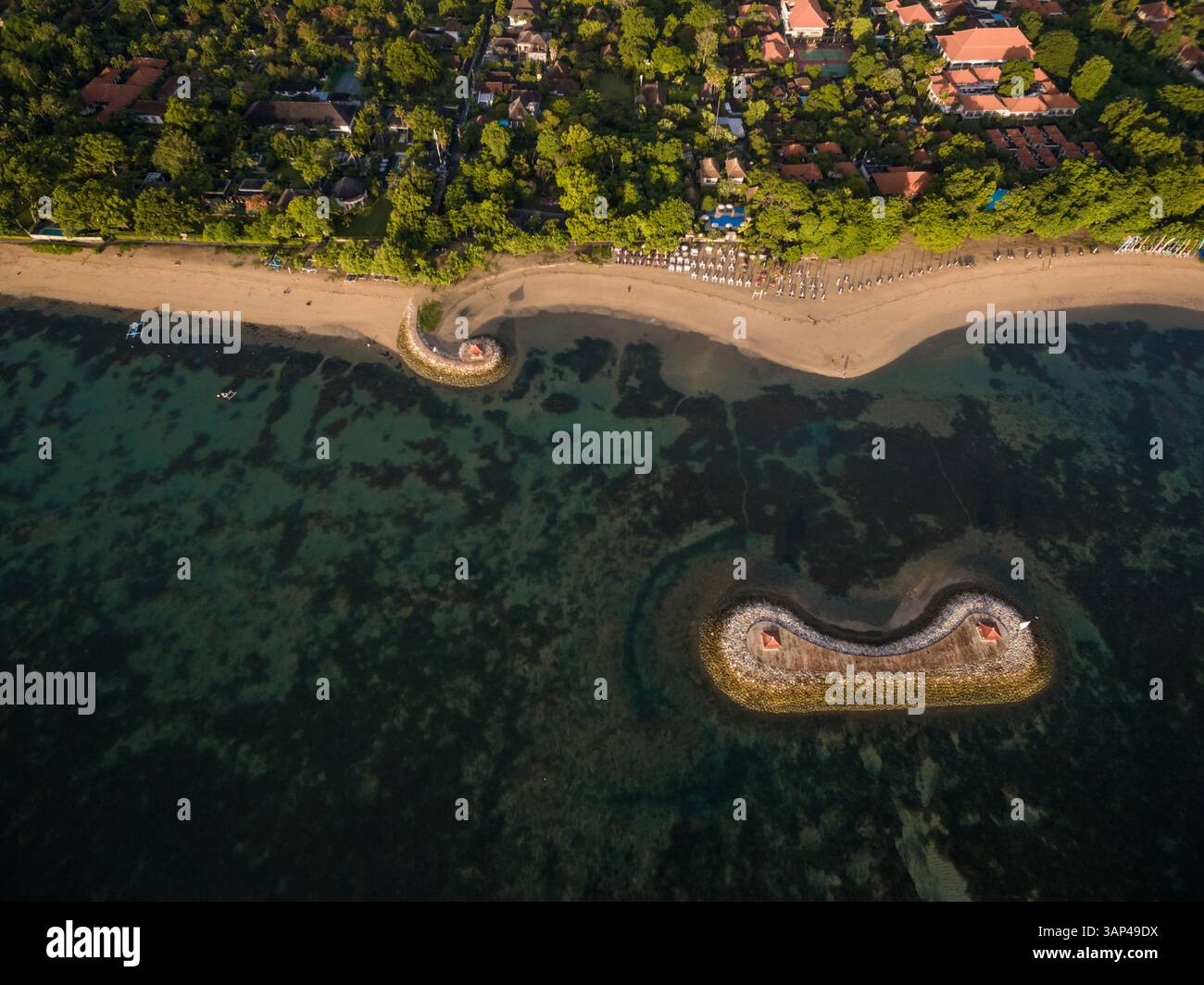 Aerial panoramic view of beachfront with parasols and deckchairs ...
