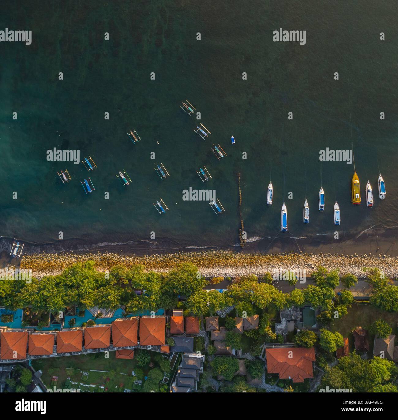 Aerial view of pump boats and yachts by coast with residential ...