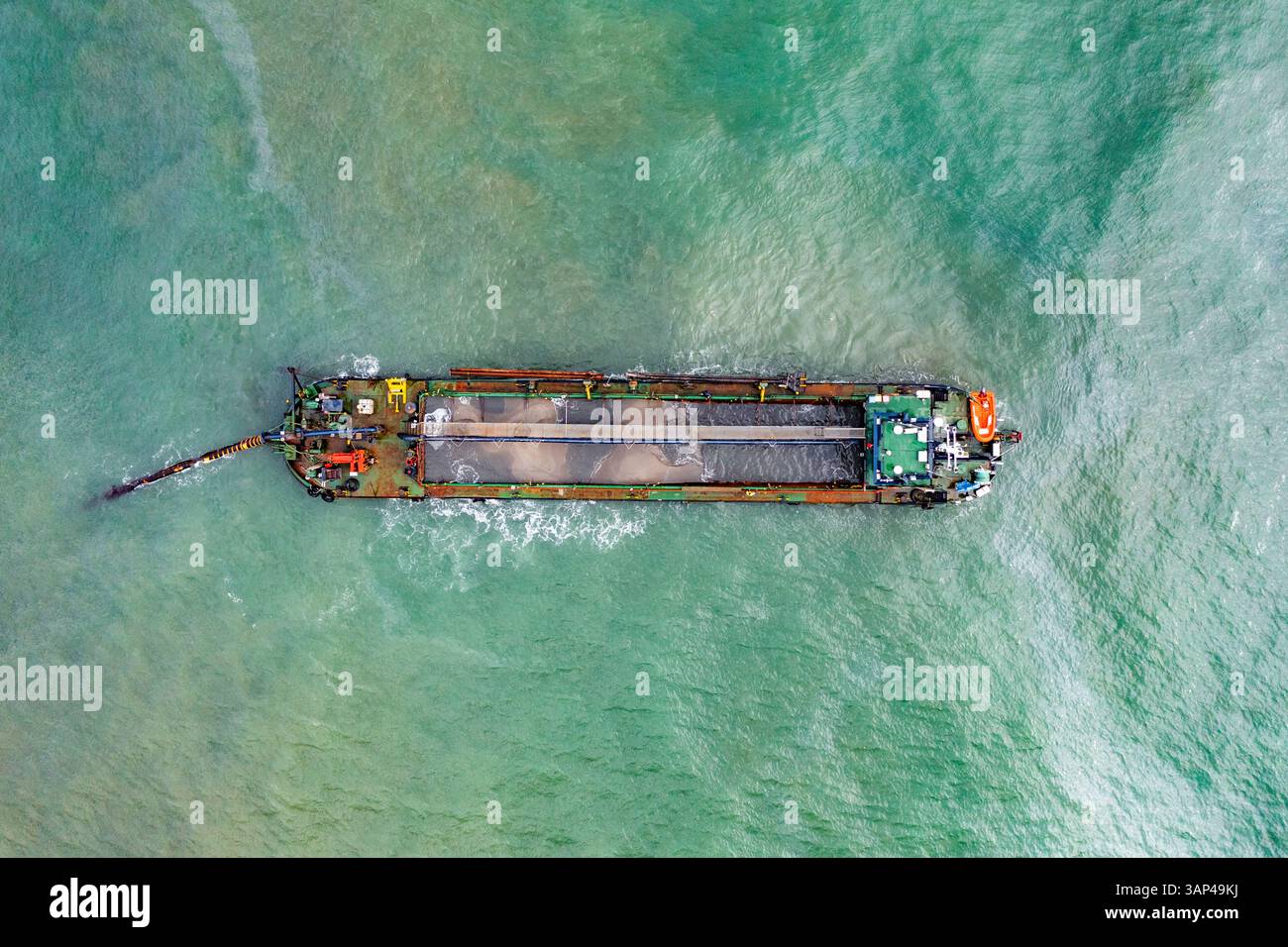 Aerial view of a container ship along the Mediterranean Sea coast in ...