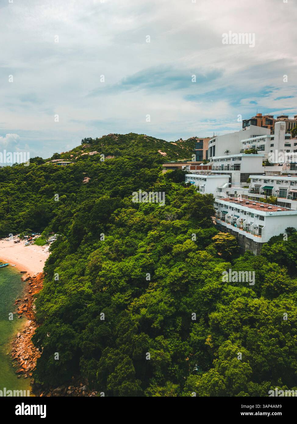 Aerial view of picturesque beach and serene ocean with luxury buildings ...