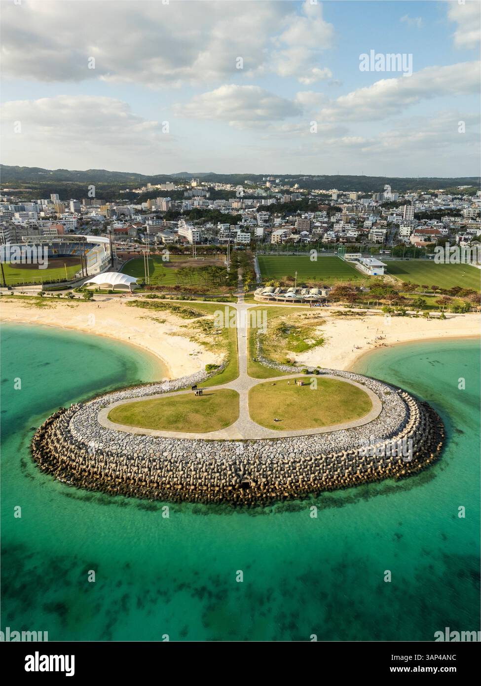 Aerial view of seikinomori beach with sandy shoreline and vibrant blue ...