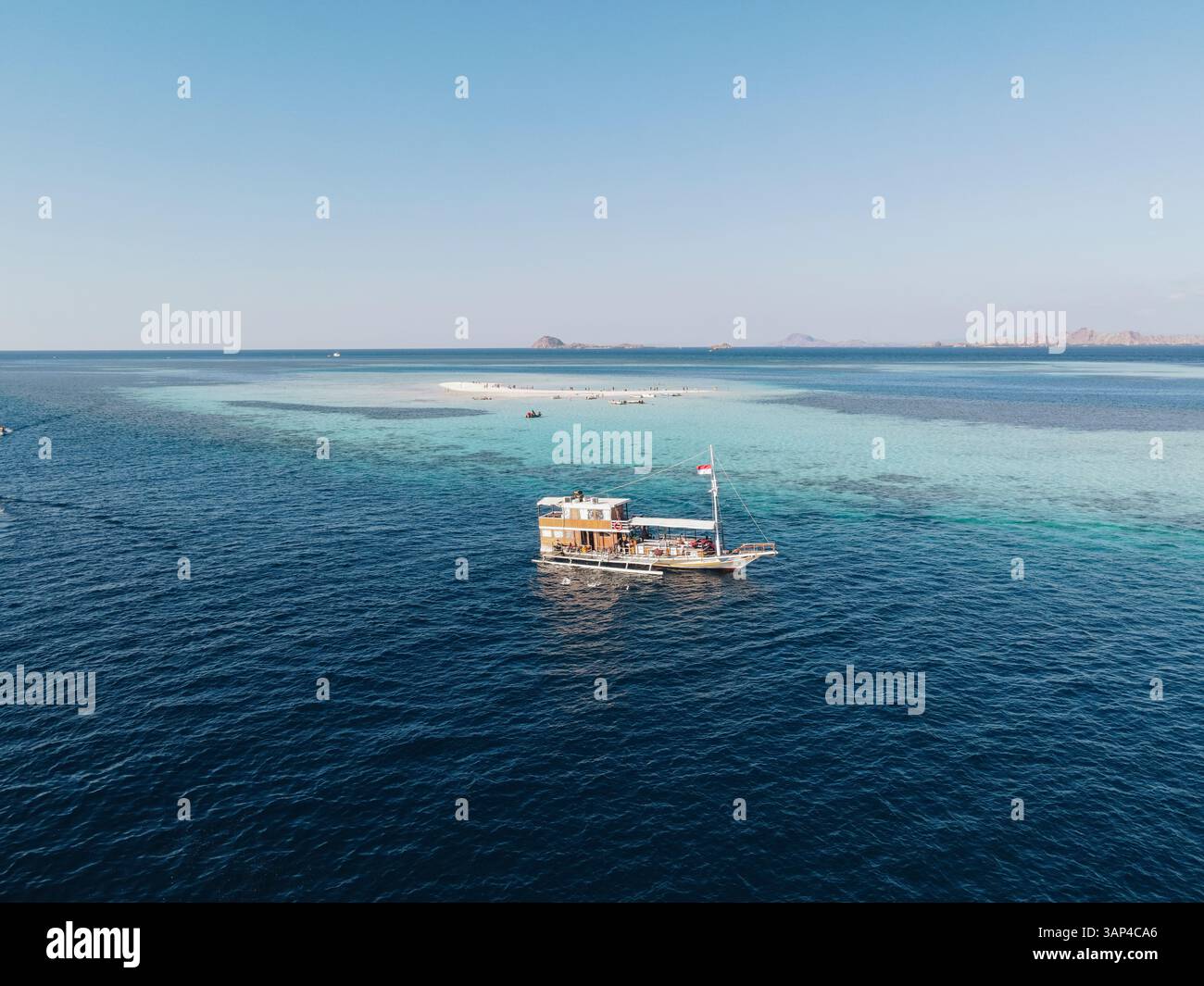 Aerial view of traditional boats Pinisi schooner sailing to the Taka ...