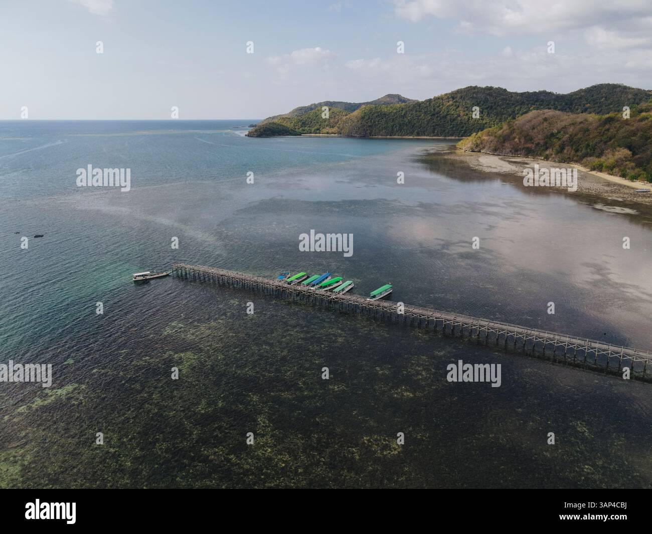Aerial drone view of Rangko island harbor with long bridge pier and ...