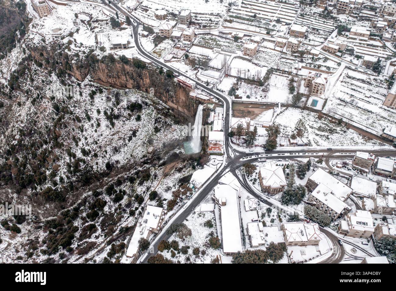 Aerial view of Jezzine village under the snow with a waterfall along ...