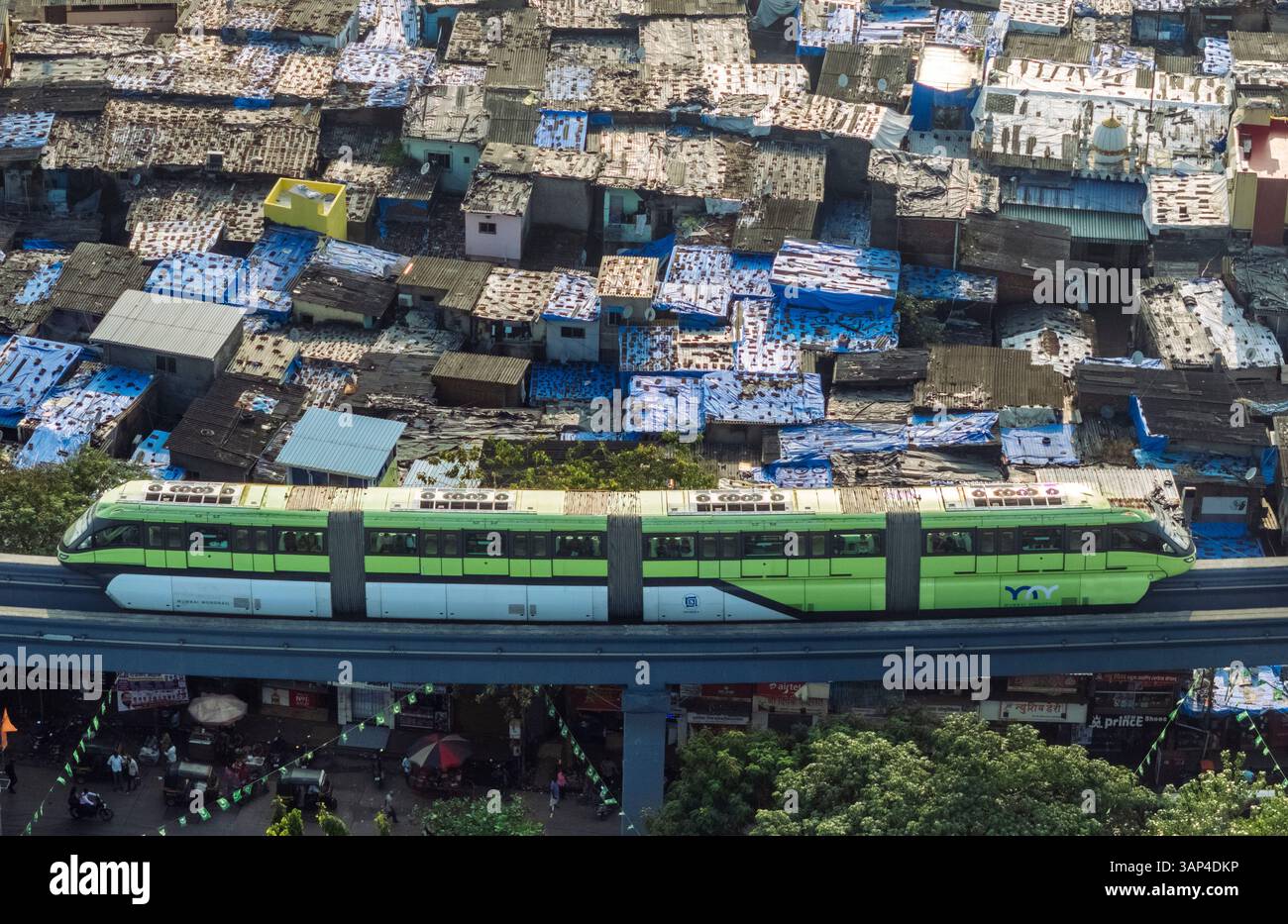 Aerial view of vibrant monorail traversing through colorful slums and ...