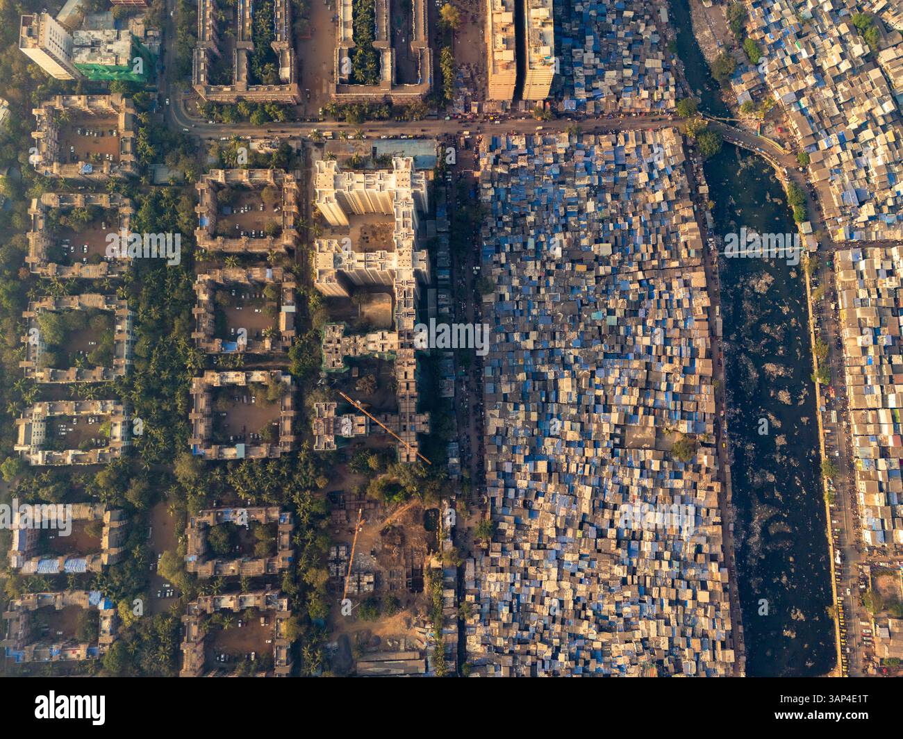 Aerial view of densely populated slums and buildings in a vibrant urban neighborhood, Dharavi ...