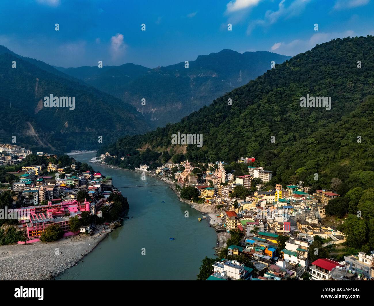 Aerial view of the serene Ganga River surrounded by vibrant mountains ...