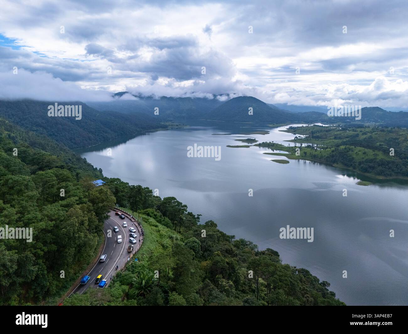 Aerial view of Umiam Lake surrounded by lush green forests and clouds ...
