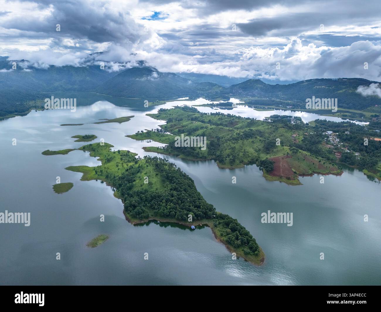 Aerial view of Umiam Lake surrounded by lush green forest and clouds ...