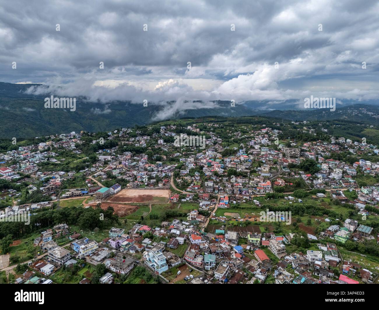 Aerial view of serene Shillong city surrounded by lush green forest and ...