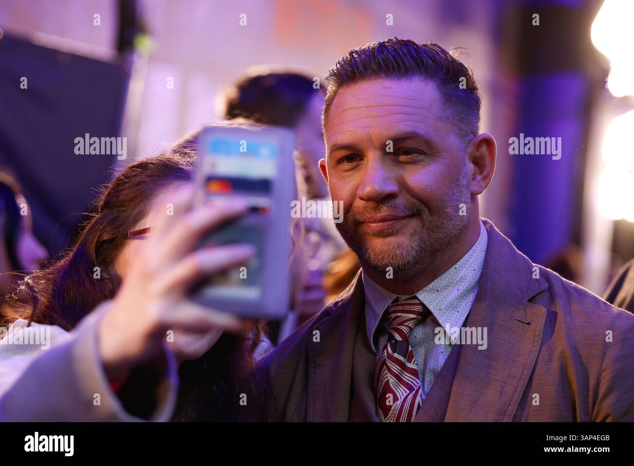 Tom Hardy poses for a selfie upon arrival at the World premiere of the ...