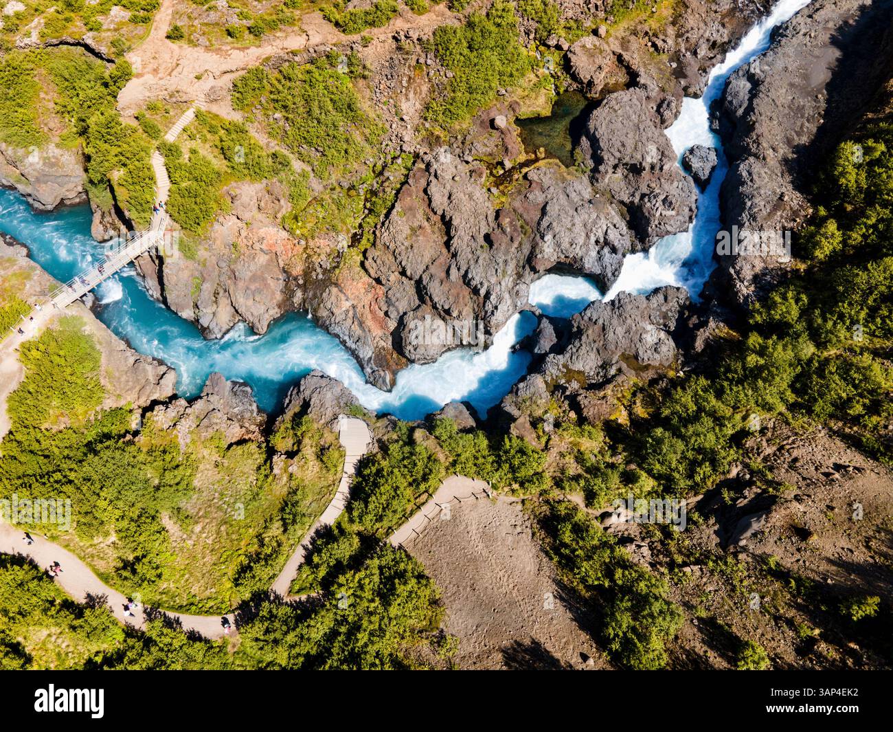 Aerial view of the majestic Hraunfossar Waterfall cascading through ...
