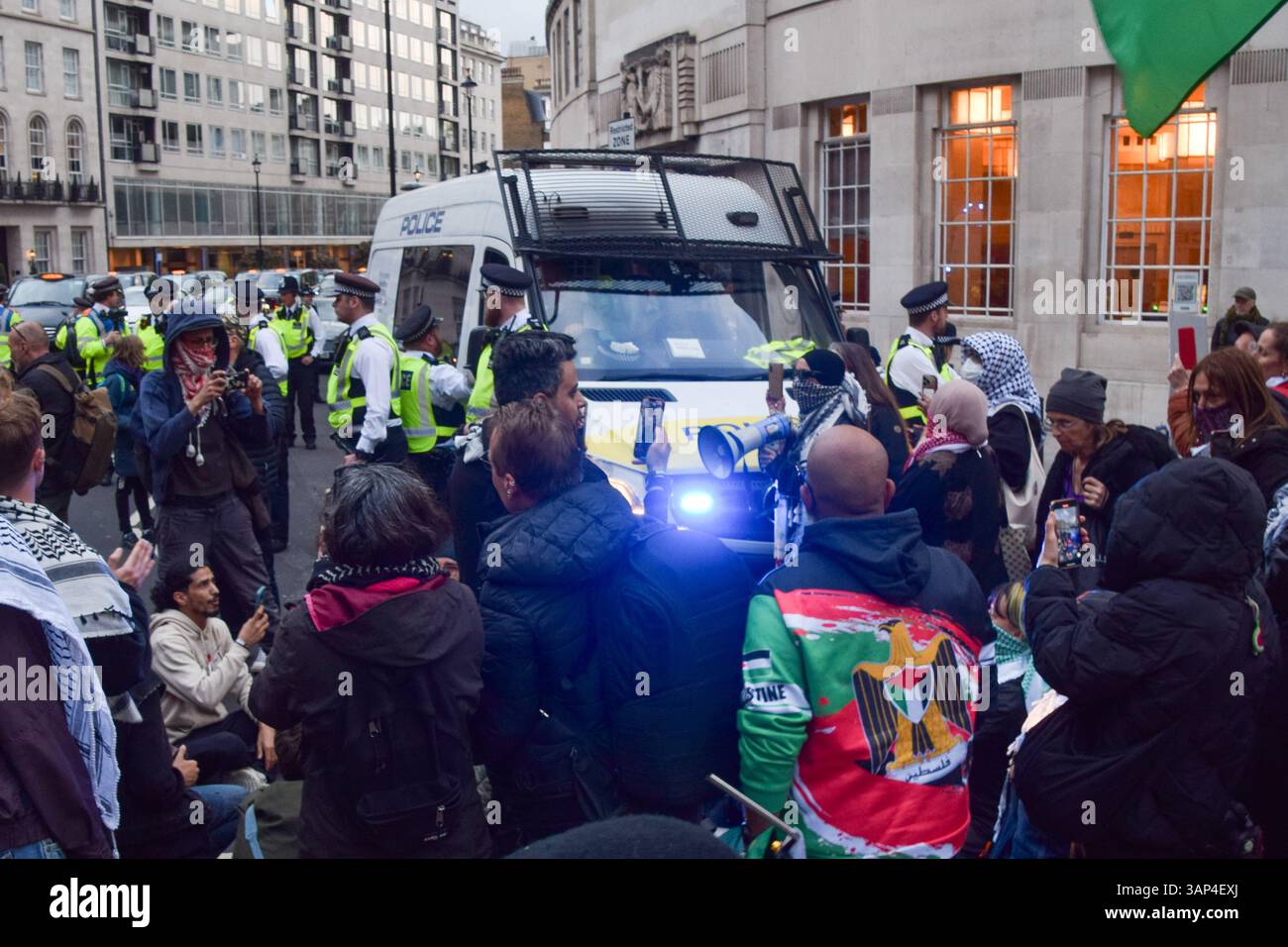 London, UK. 15th April 2025. Protesters try to prevent a police van ...