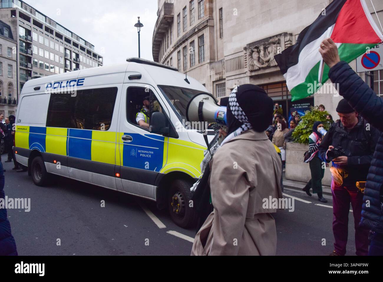 London, UK. 15th April 2025. Protesters try to prevent a police van ...