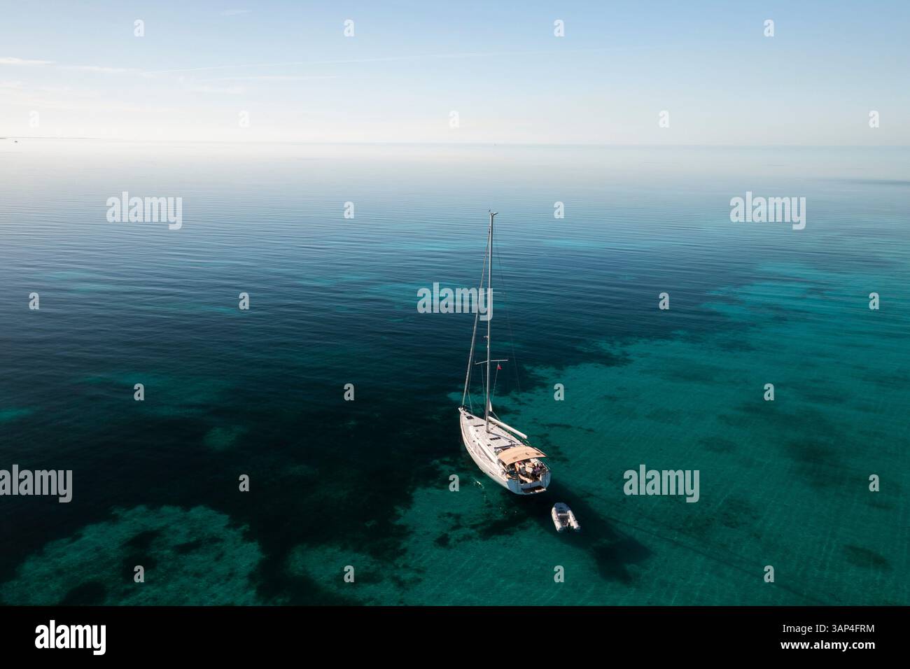 Aerial view of a sail boat on the shallow water of the Berry Islands ...