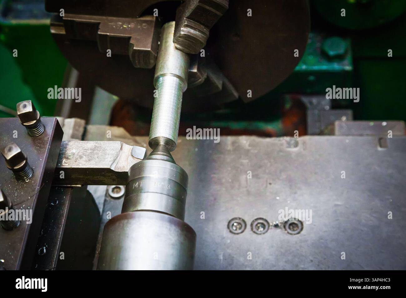 Lathe in a workshop with a clamped steel workpiece for turning Stock ...