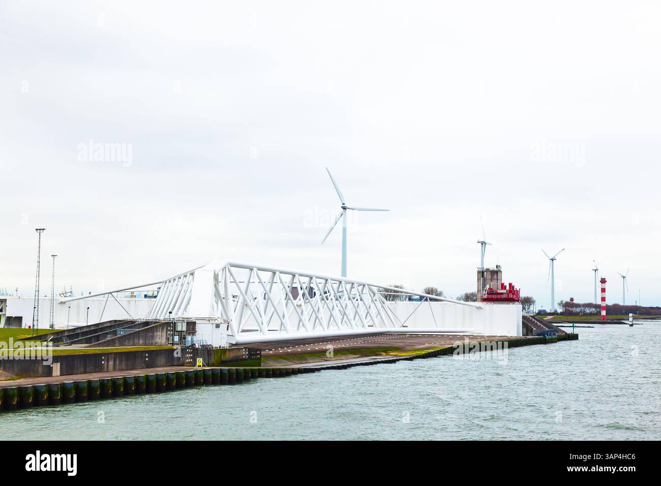 A canal in the suburbs of Rotterdam with a sliding bridge and wind ...