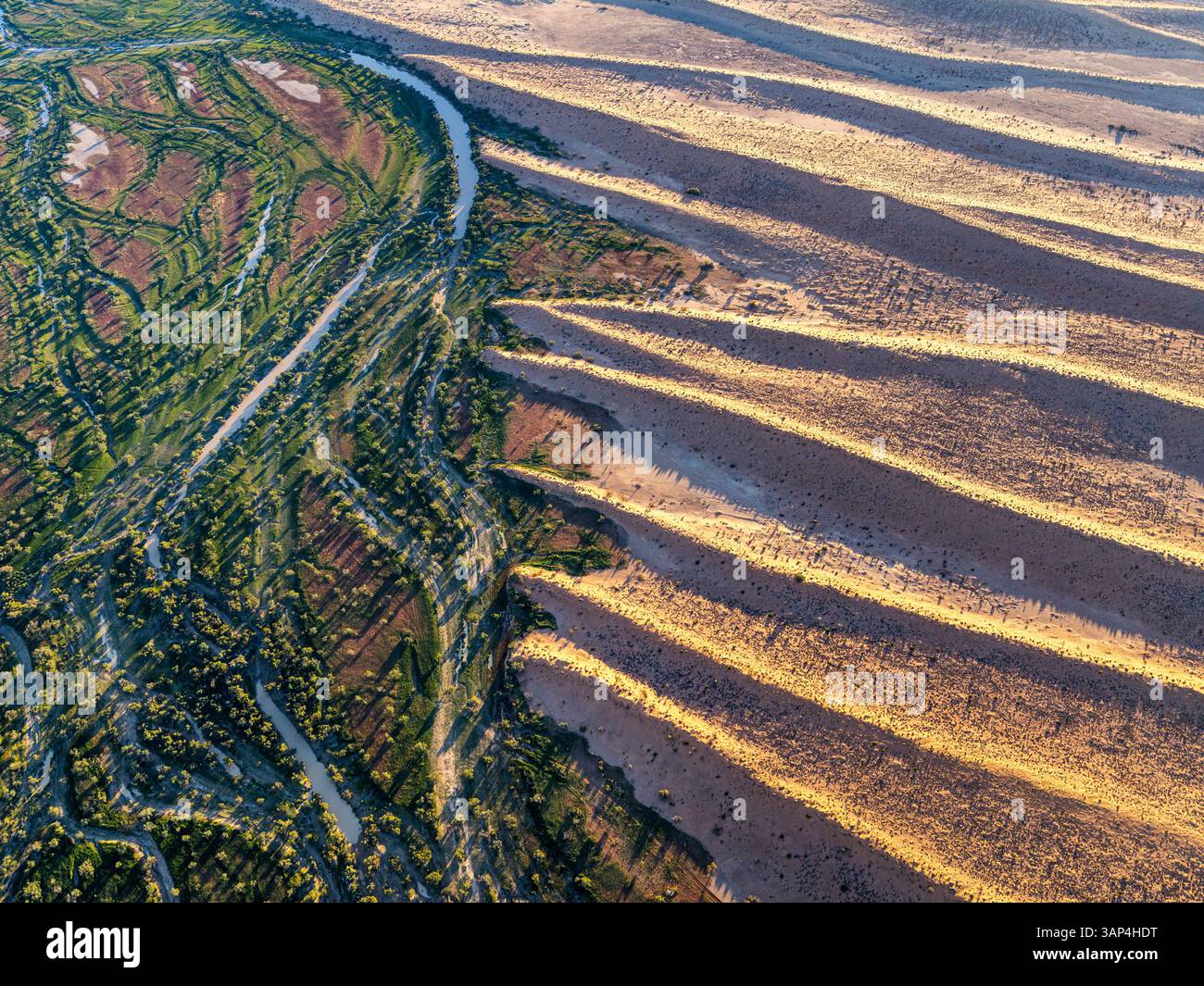 Aerial view of expansive flood plain patterns and desert shadows with ...