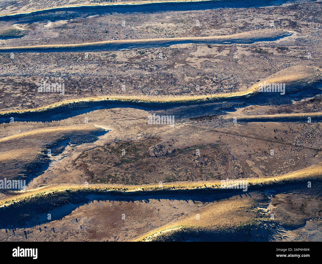 Aerial view of sand dunes and rugged terrain in remote outback, South ...