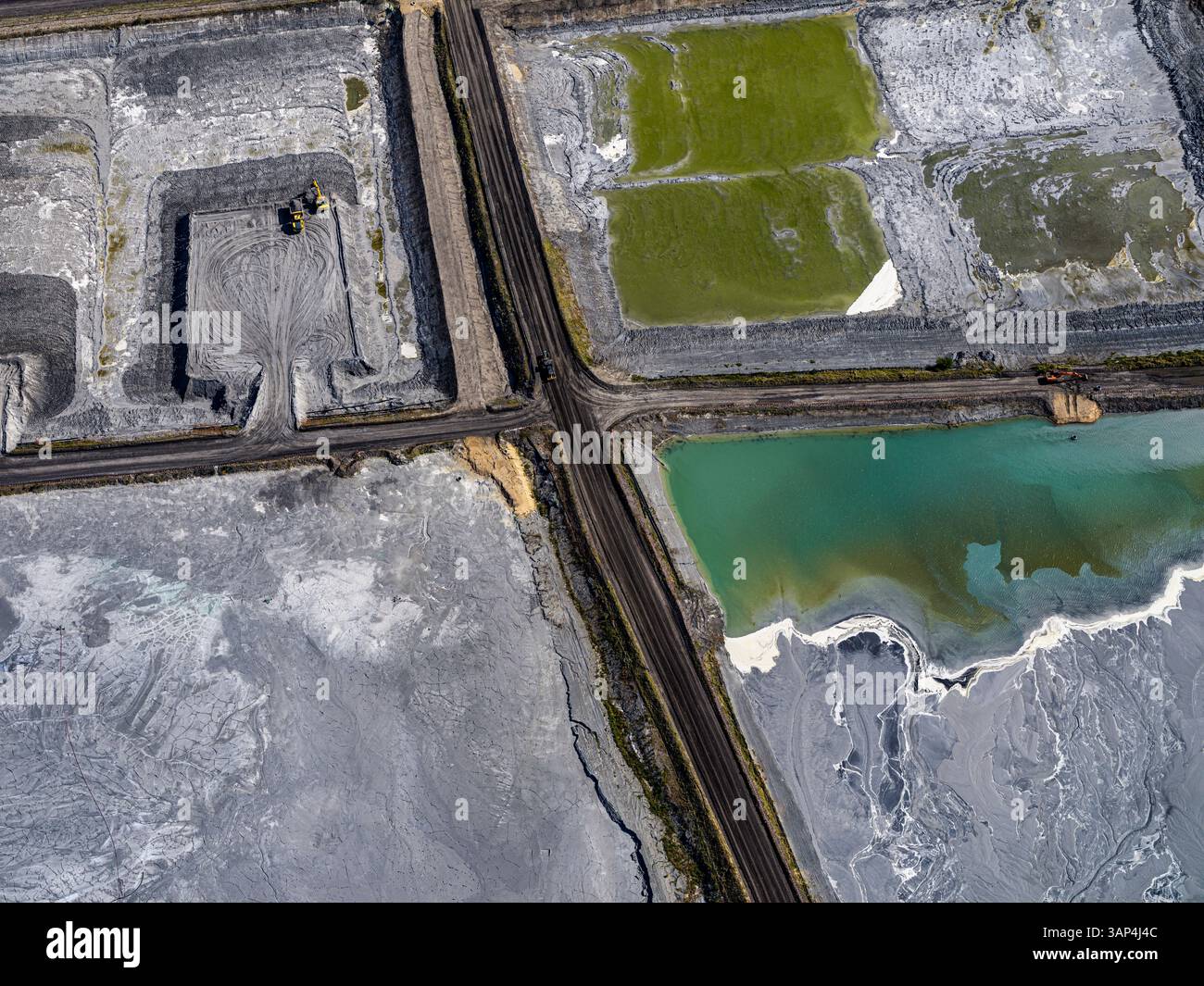 Aerial view of industrial coal mining site with tailing pond, roads ...