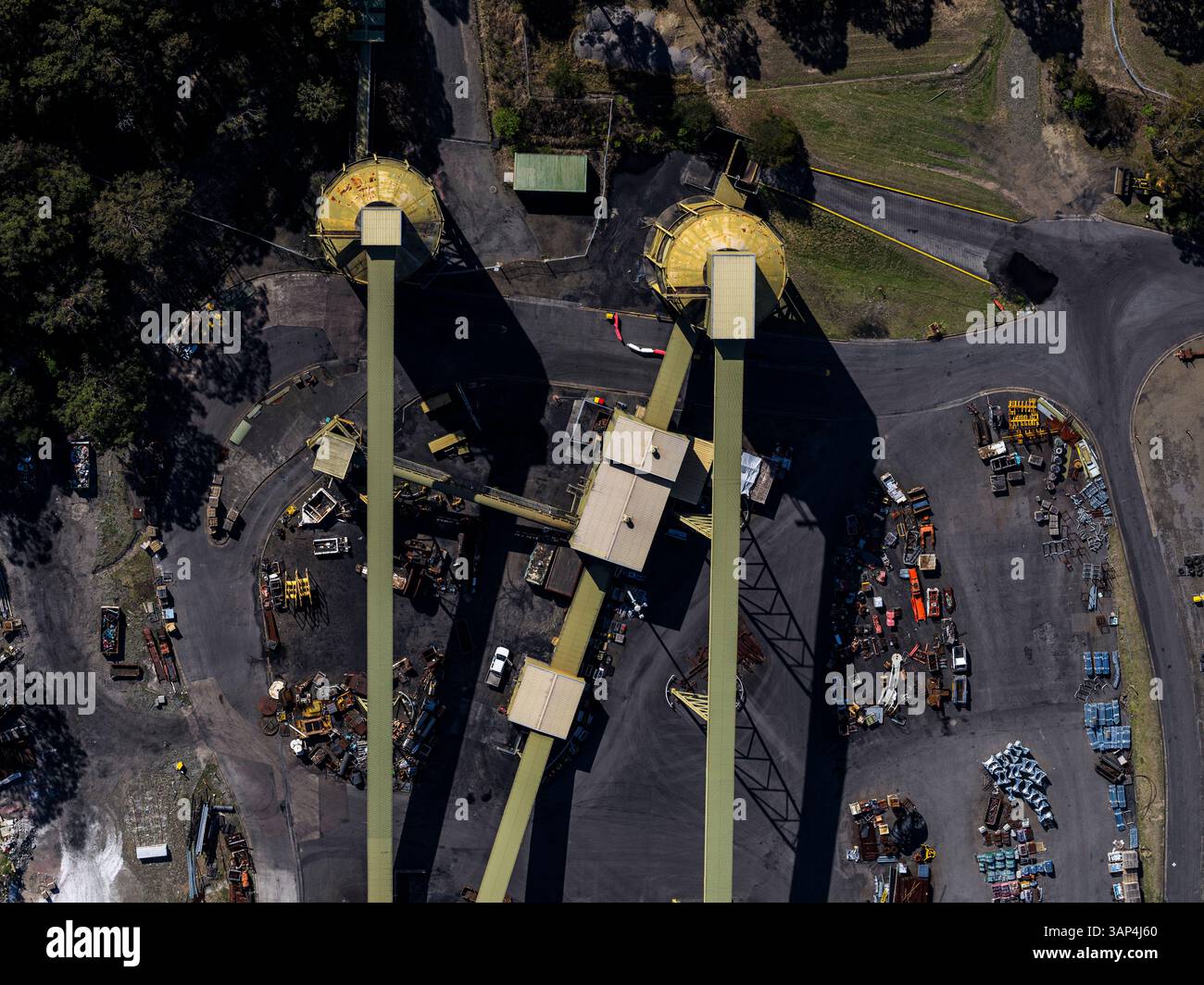 Aerial view of organized coal mining facility with machinery and towers ...