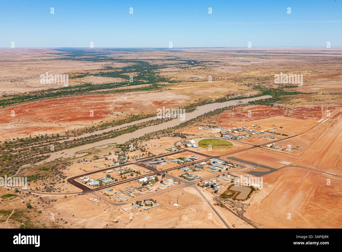 Aerial view of remote outback town Birdsville with river and desert ...