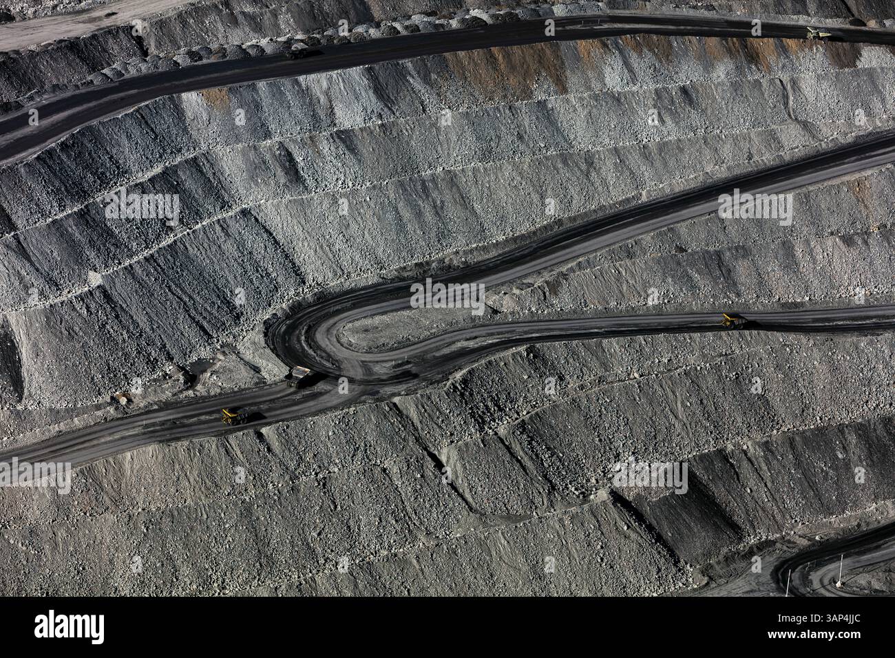 Aerial view of open cut coal mining with heavy machinery and roads ...