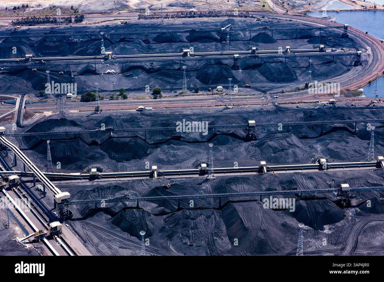 Aerial view of coal loading operations with machinery and conveyor ...